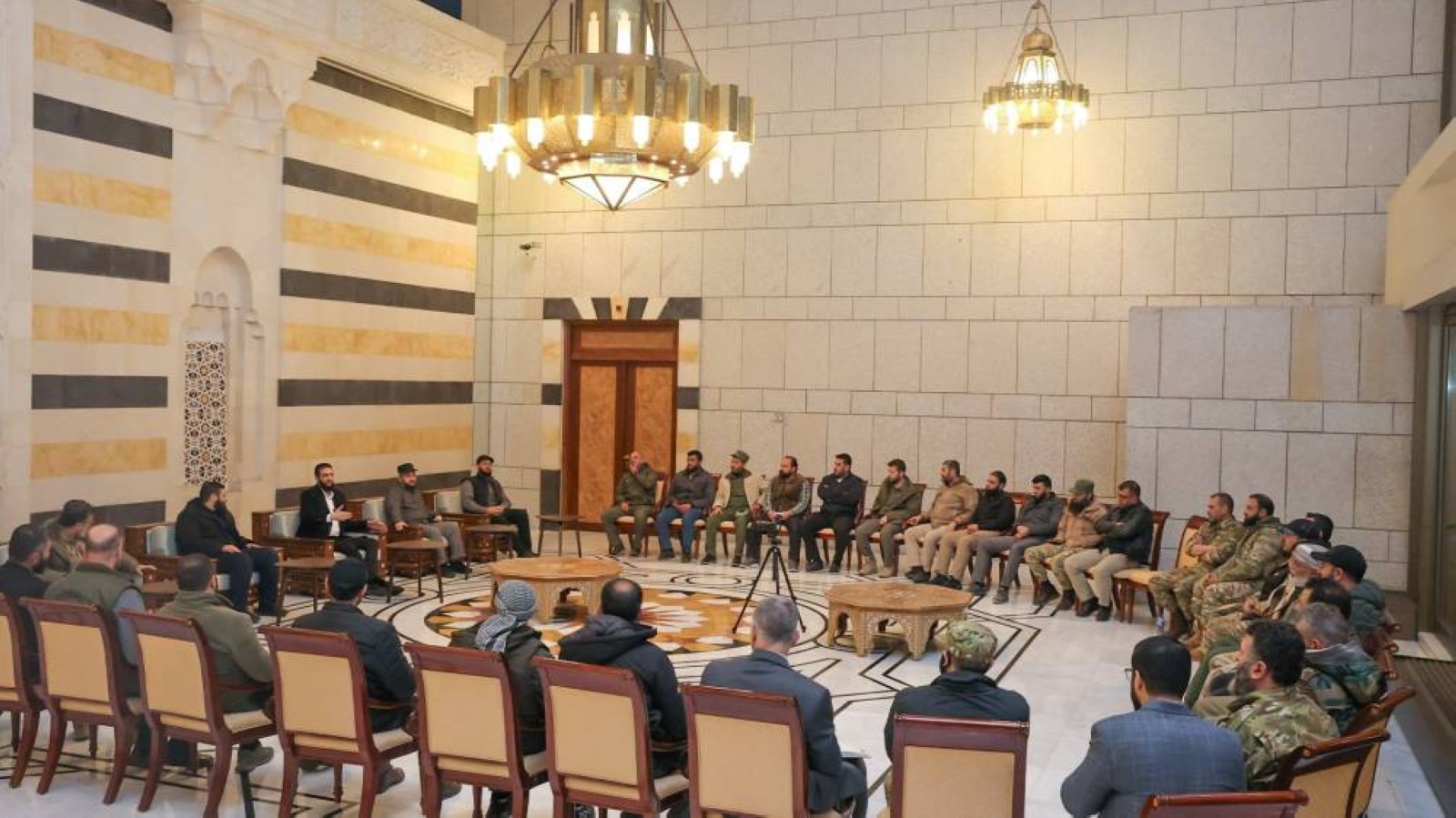 Syria's new leader says all weapons to come under 'state control'