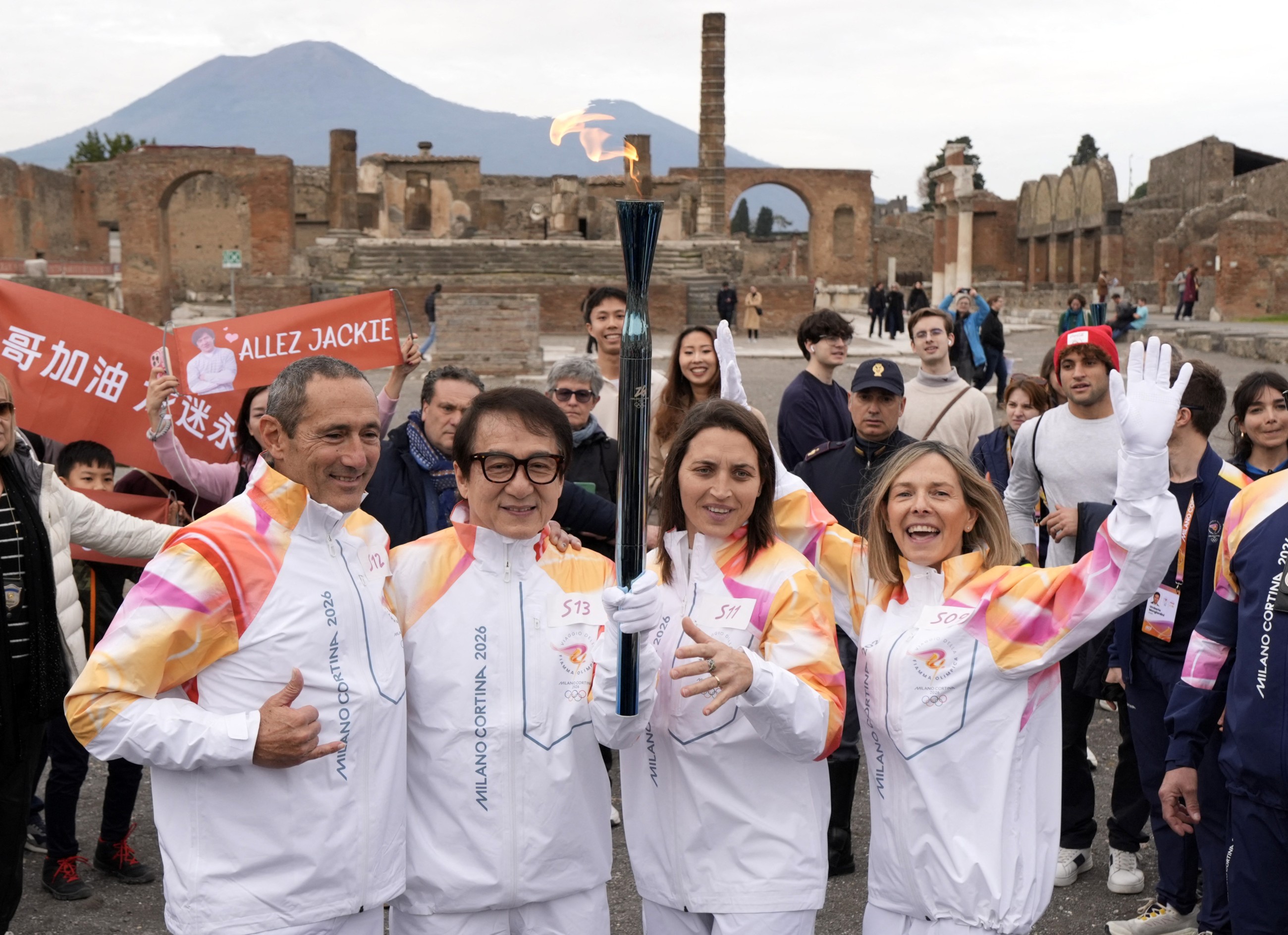 Actor Jackie Chan carries the Milan Cortina Olympic torch...
